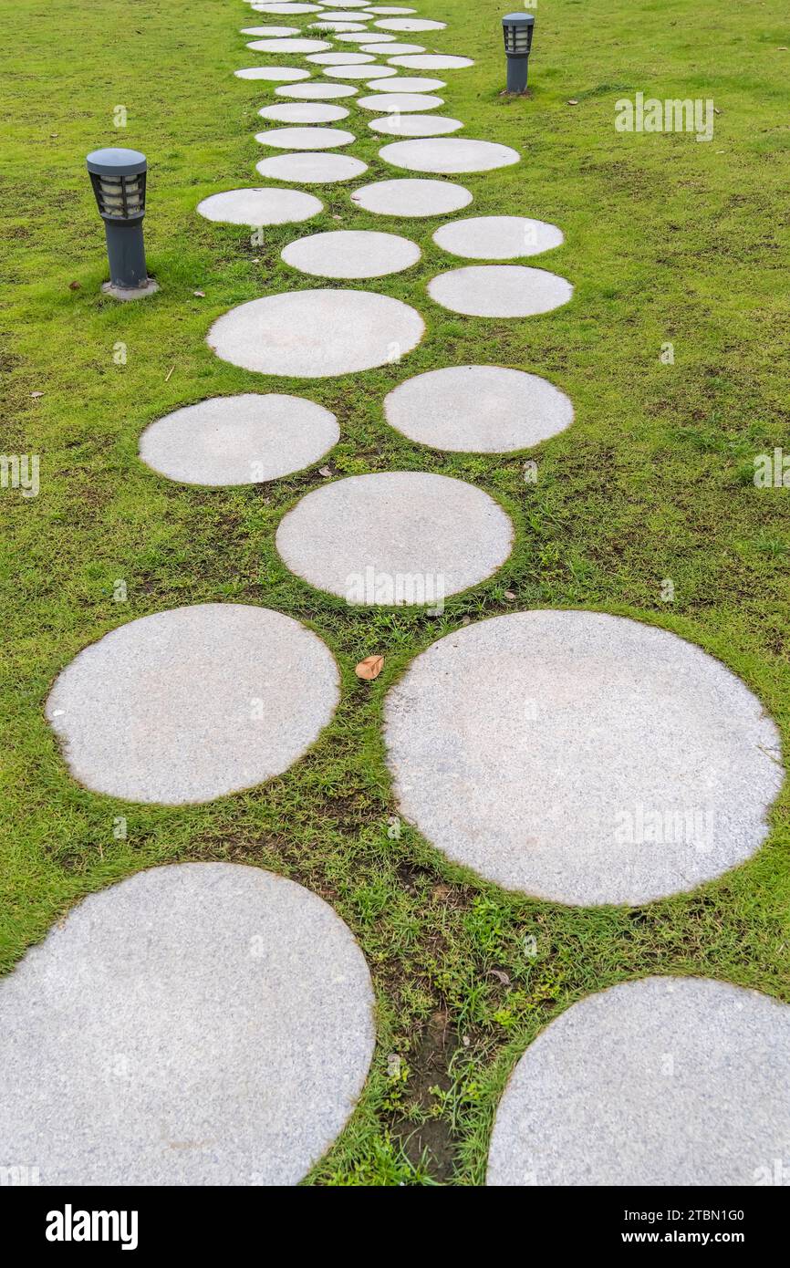 Walkway in the park garden made of round rock Stock Photo - Alamy