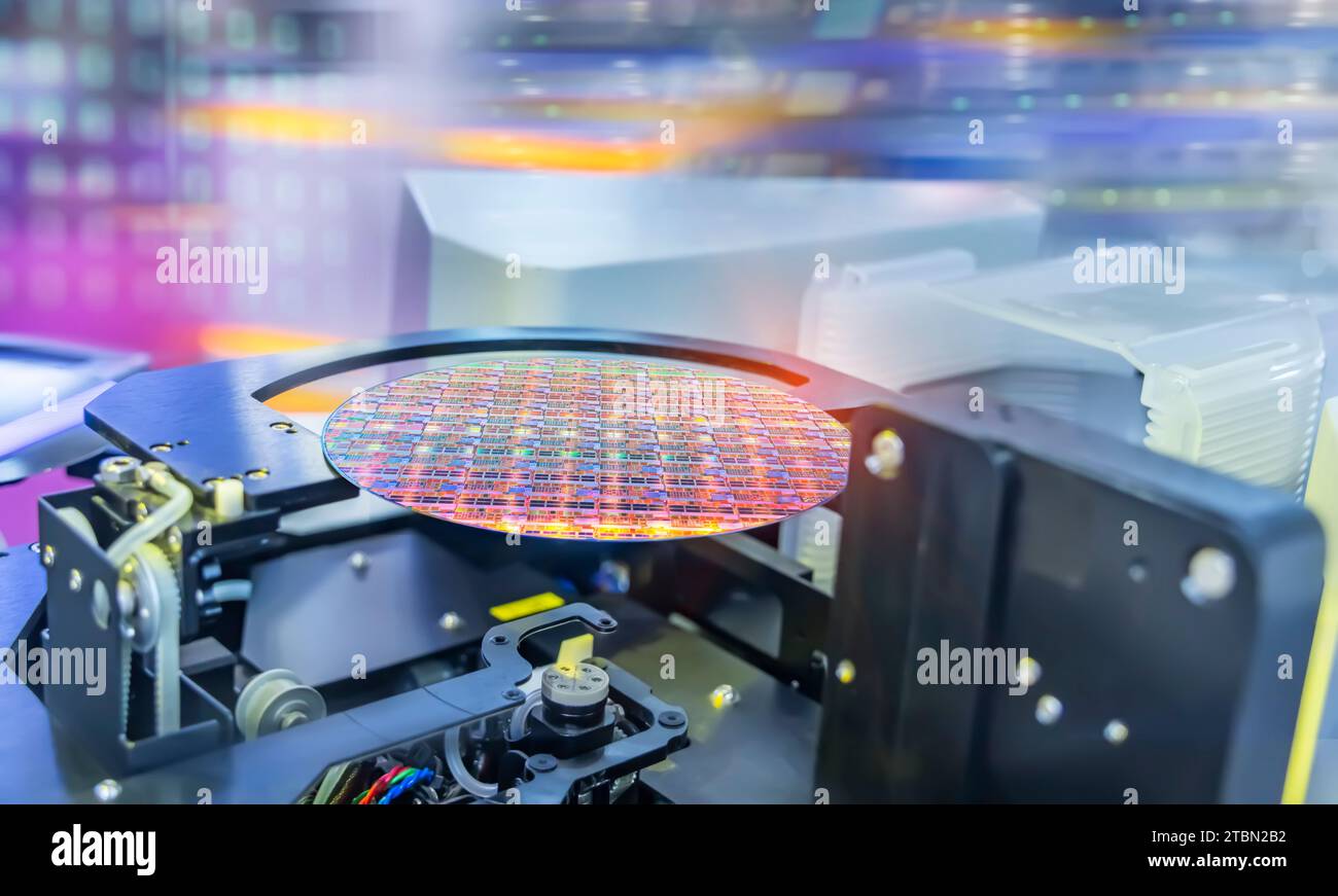 Semiconductor and Computer Chip Manufacturing at Fab or Foundry with robotic arms with silicon ...