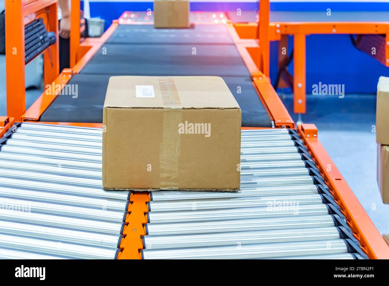 Conveyor belt with cardboard boxes at factory Stock Photo - Alamy