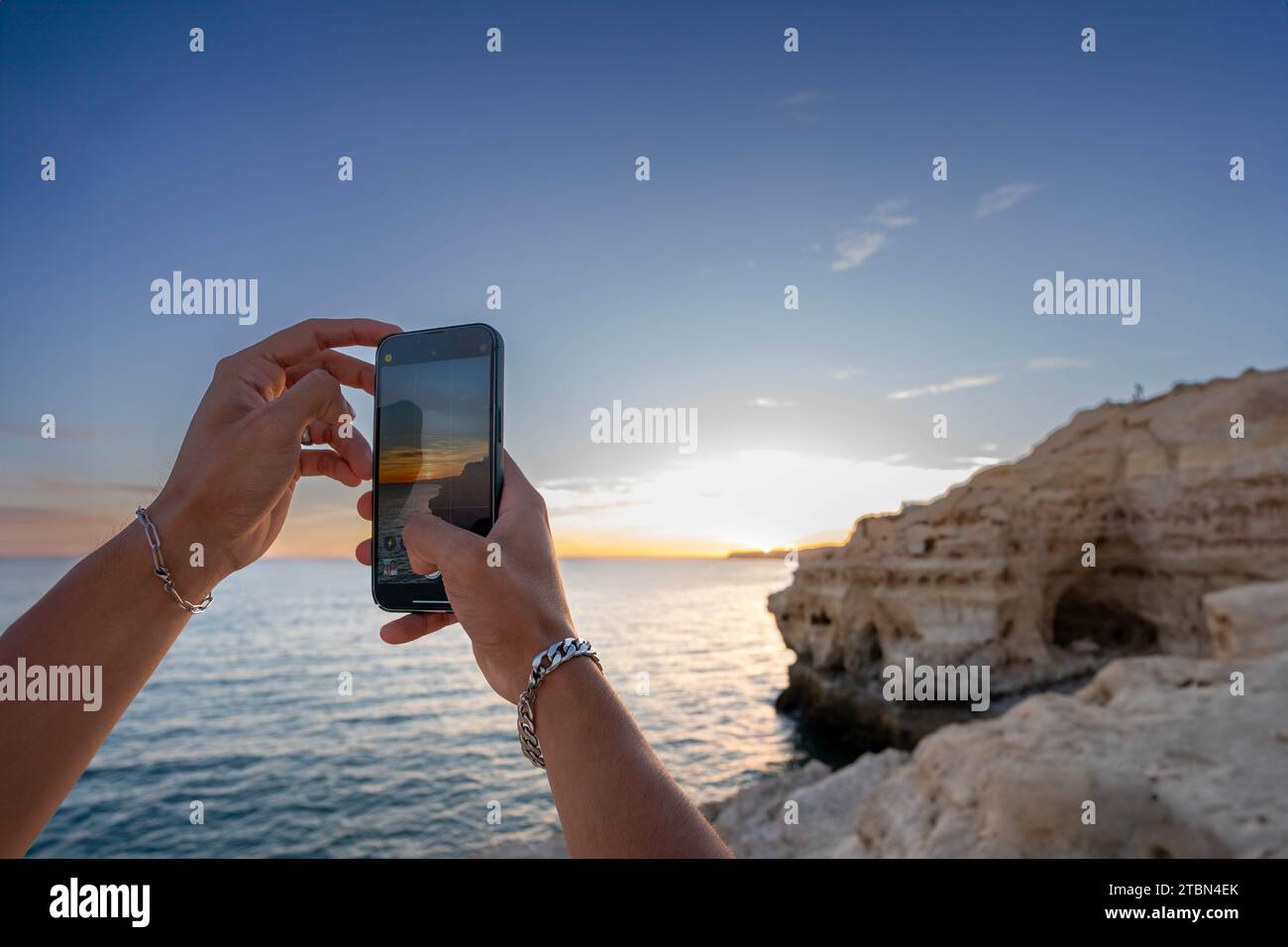 Golden Hour Moment: Young Man Hands Capturing the Ocean Sunset of ...