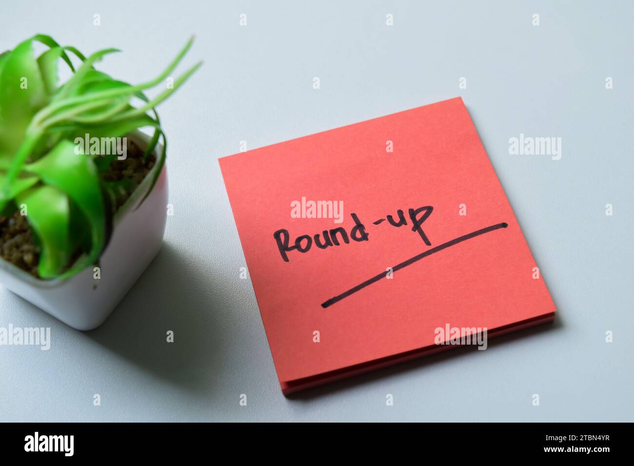 Concept of Round-up write on sticky notes isolated on white background ...