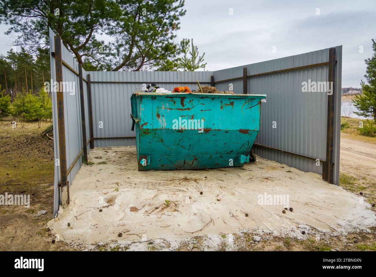 Turquoise painted rusty metal dumpster in rural Stock Photo - Alamy