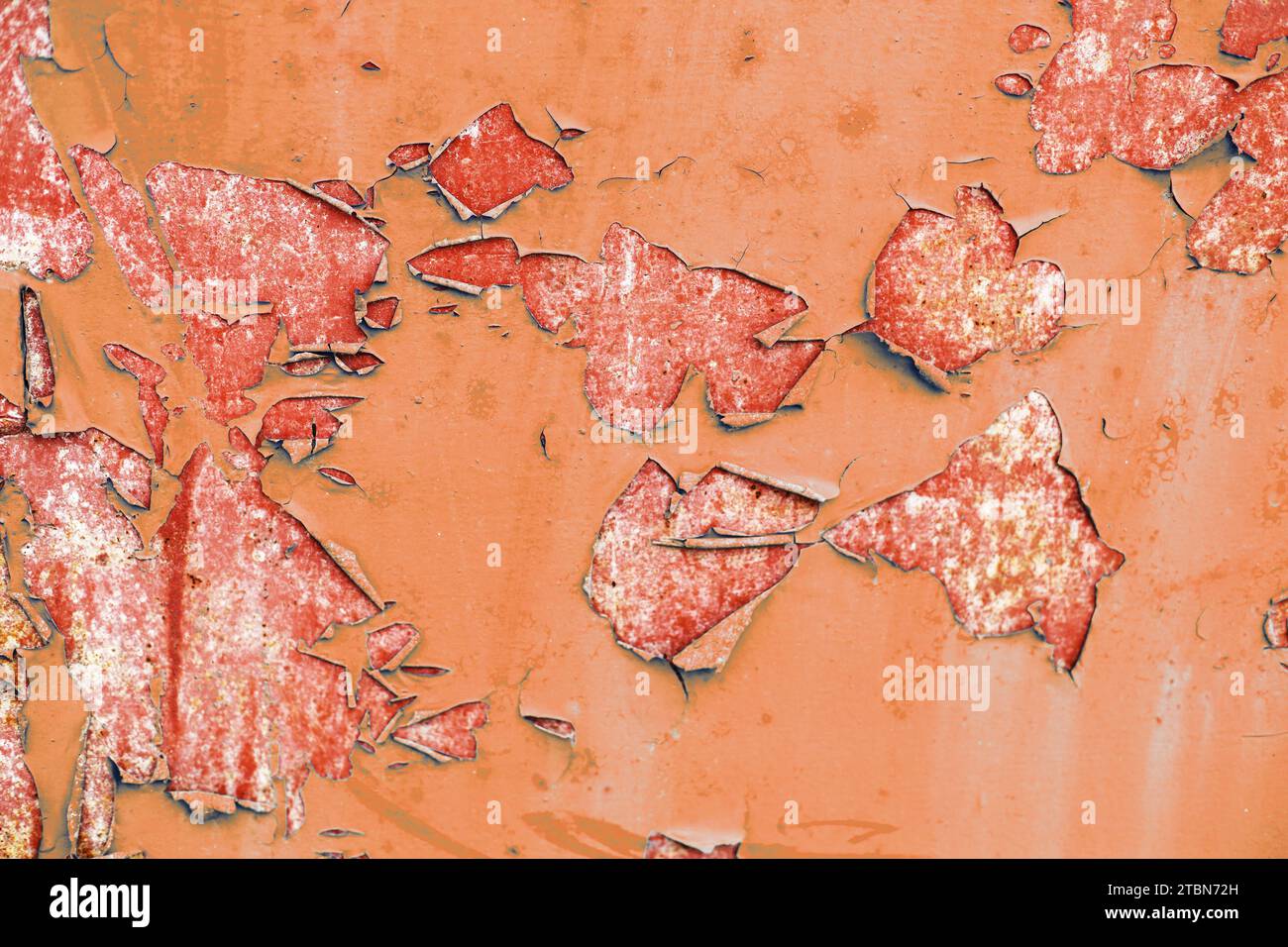 Old Peach Fuzz paint peeling from red concrete wall background. Texture ...