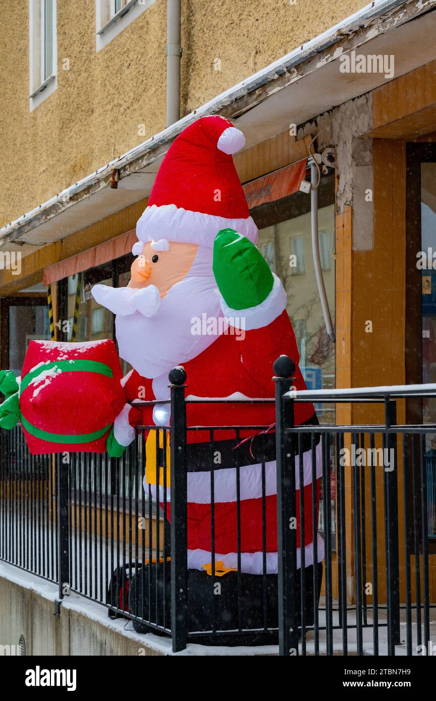 Big inflated Santa Claus standing outsid shop Stock Photo - Alamy