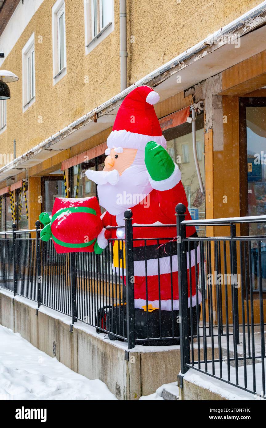 Big inflated Santa Claus standing outsid shop Stock Photo - Alamy