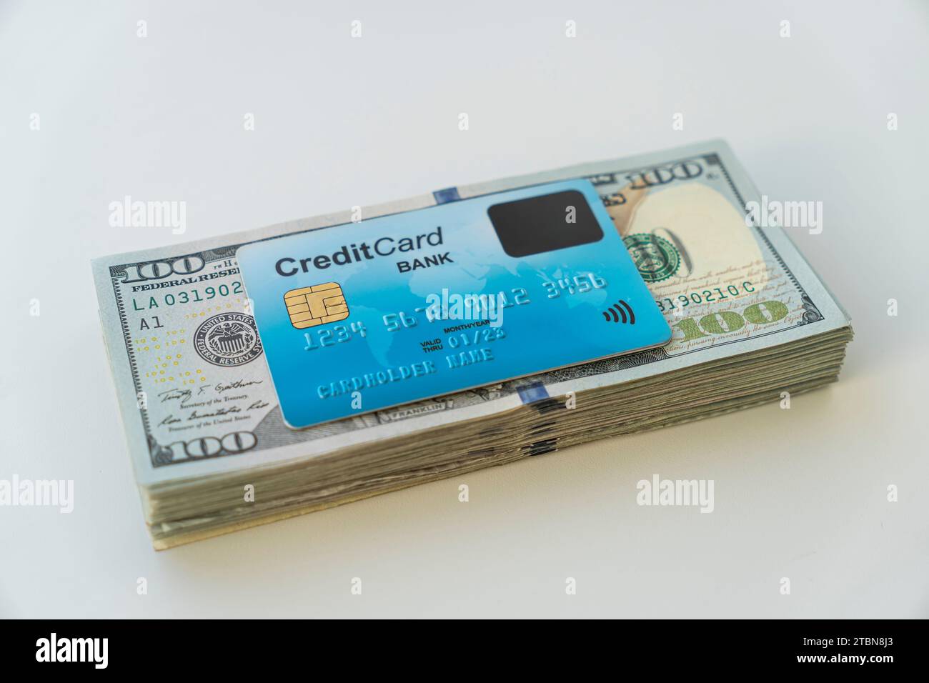 Credit cards and dollar bills on white background. a blue plastic bank ...