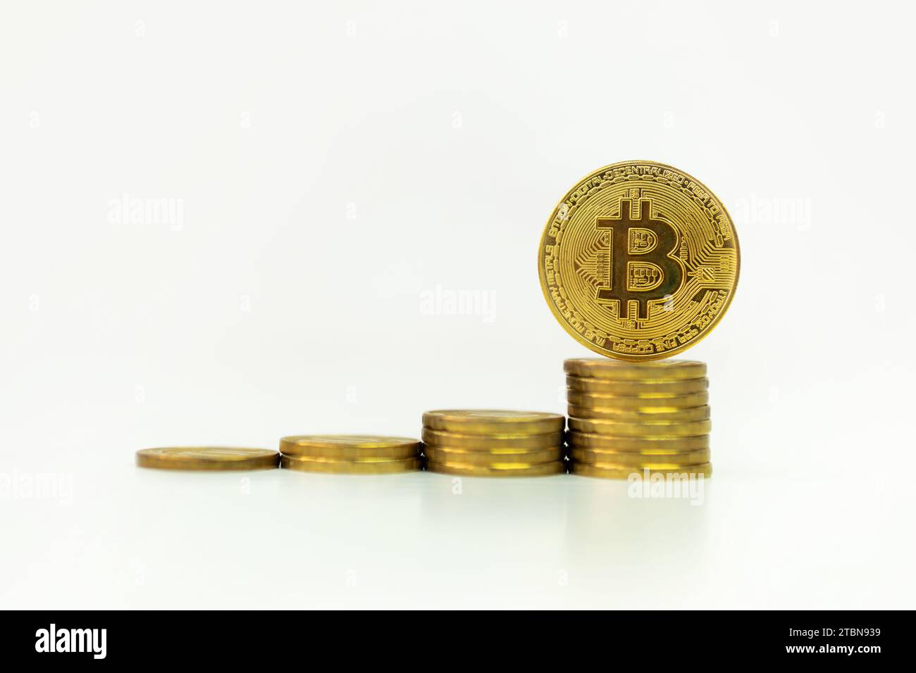 Golden coins with bitcoin symbol on a stack of coins over white ...