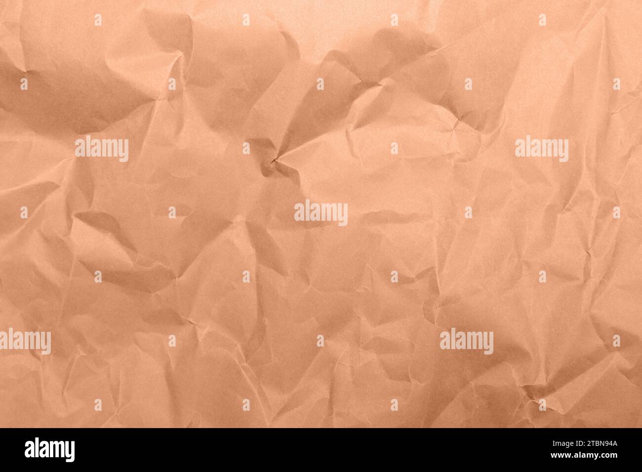 Peach fuzz, color of the year 2024, shining luxurious fabric. Wrinkled ...