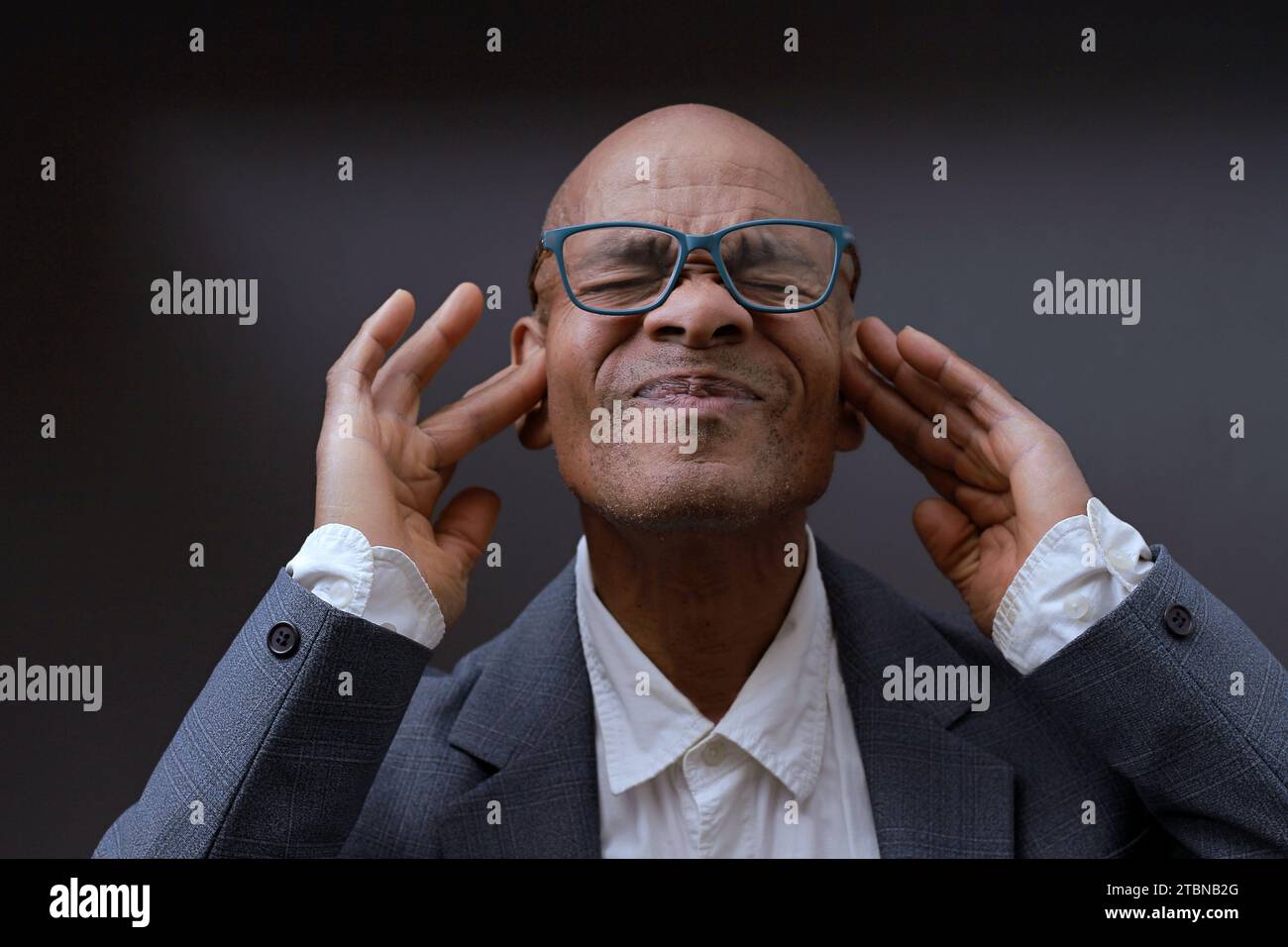 deafness suffering from hearing loss on grey black background with ...