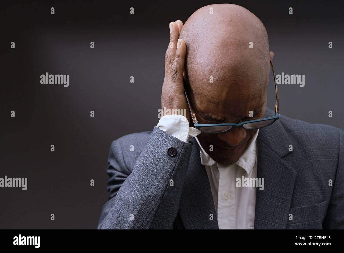 deafness suffering from hearing loss on grey black background with ...