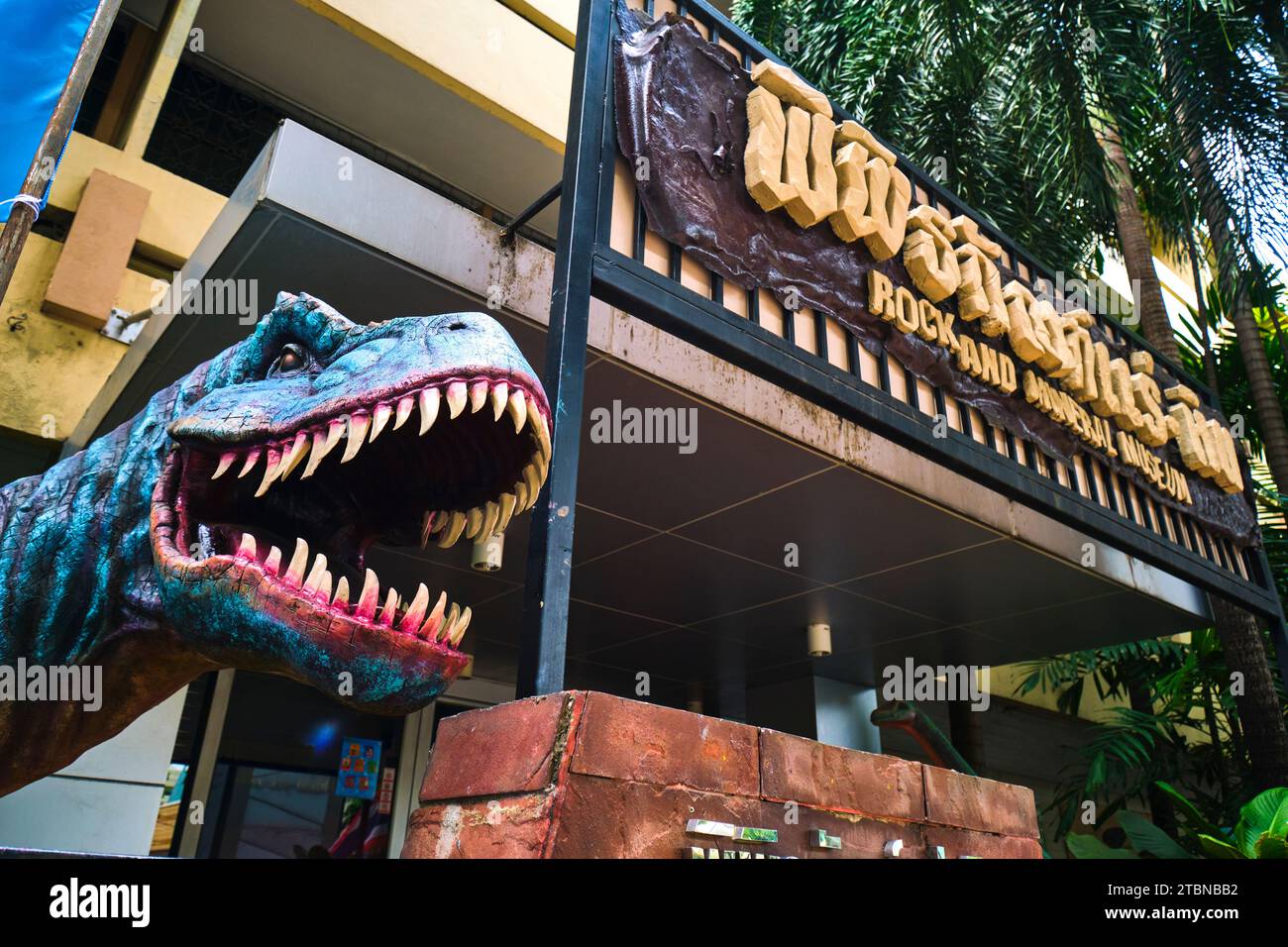 View of the front entrance sign with large T-Rex dinosaur figure. At ...