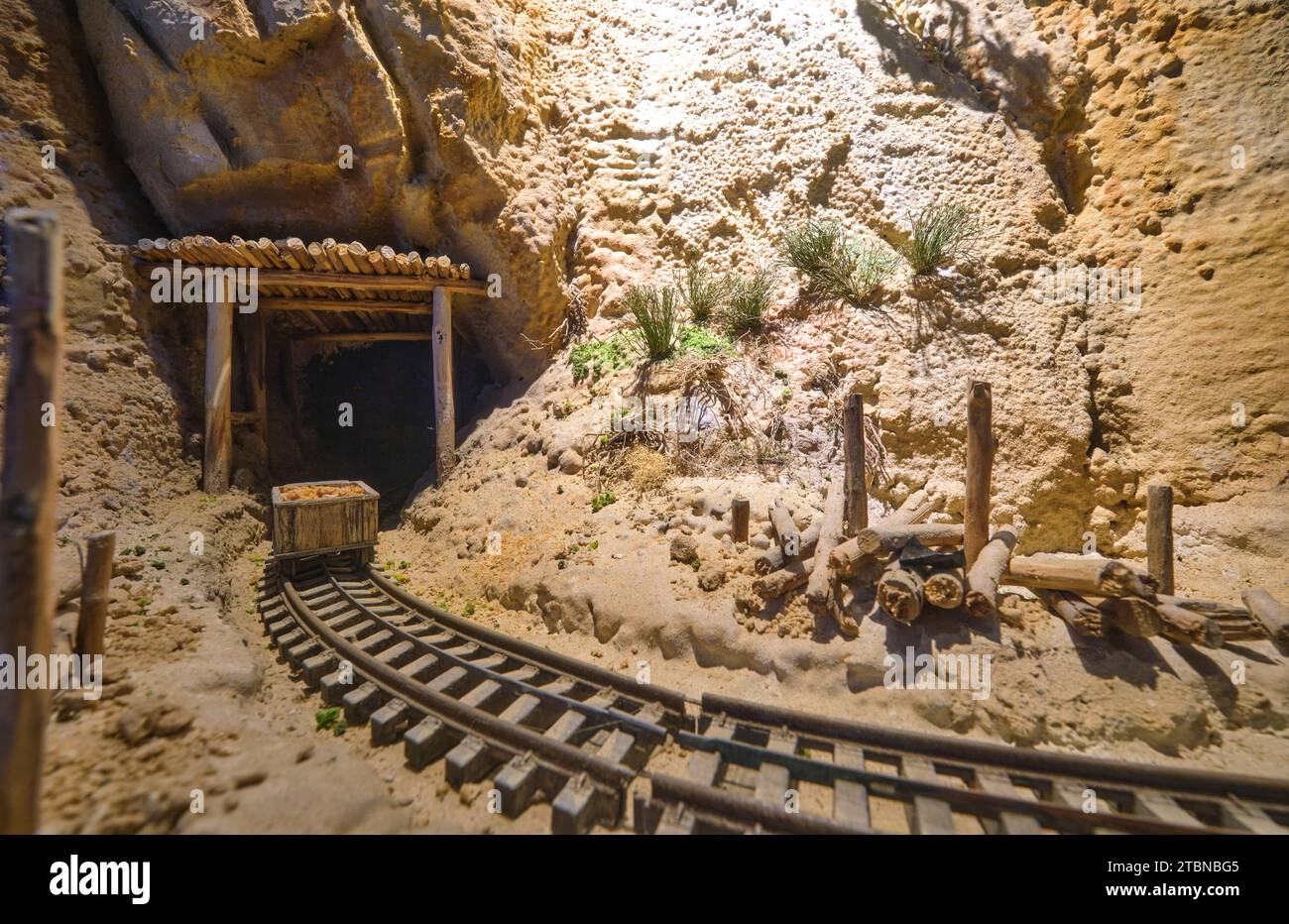 A diorama depicting the entrance to a mine shaft with small hopper car ...