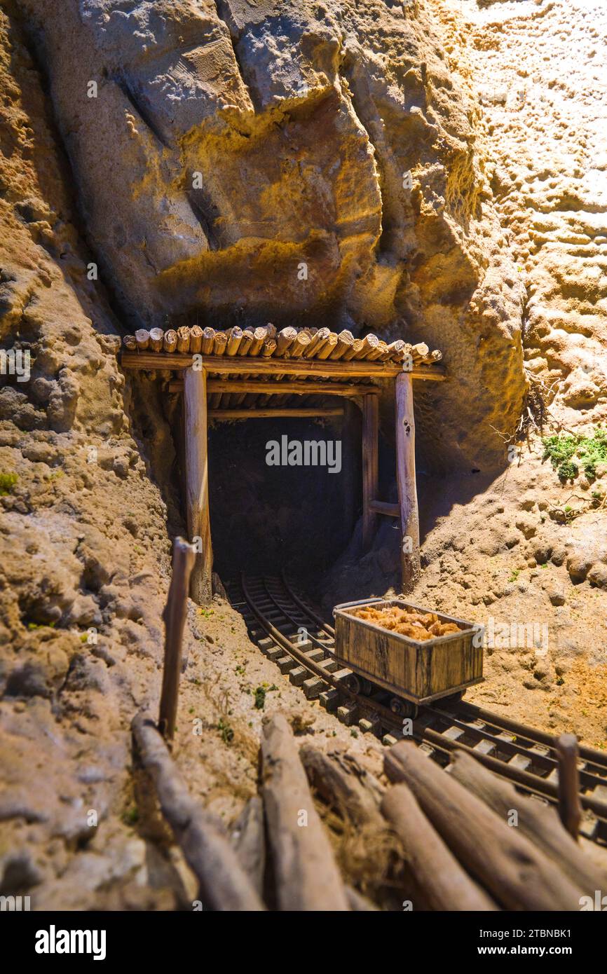 A diorama depicting the entrance to a mine shaft with small hopper car ...