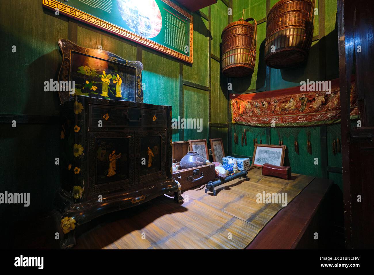 A display of a typical Chinese coolie apartment with opium pipe. At the ...