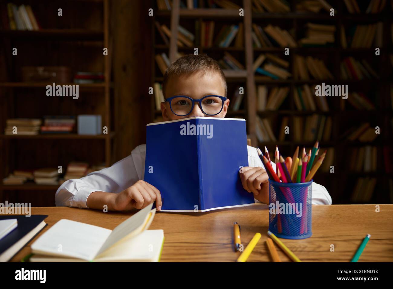 Hiding behind school desk hi-res stock photography and images - Alamy