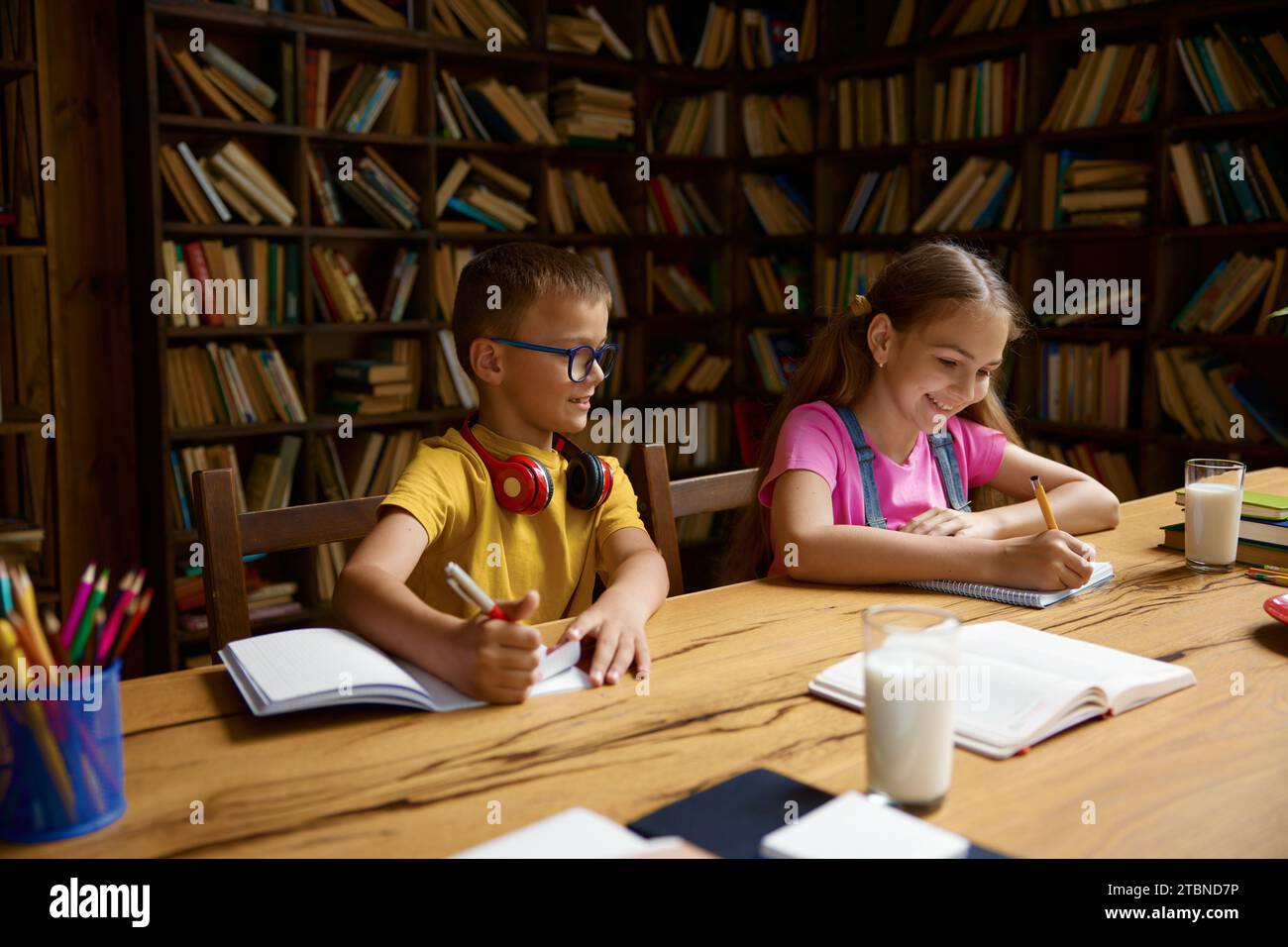 Smart small brother and sister studying doing homework together at home ...