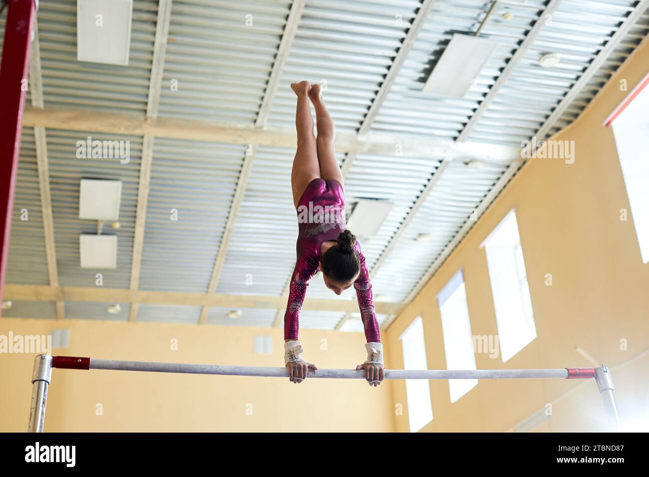 Training Girl Gymnast Pausing in Handstand on Uneven Bars Stock Photo ...