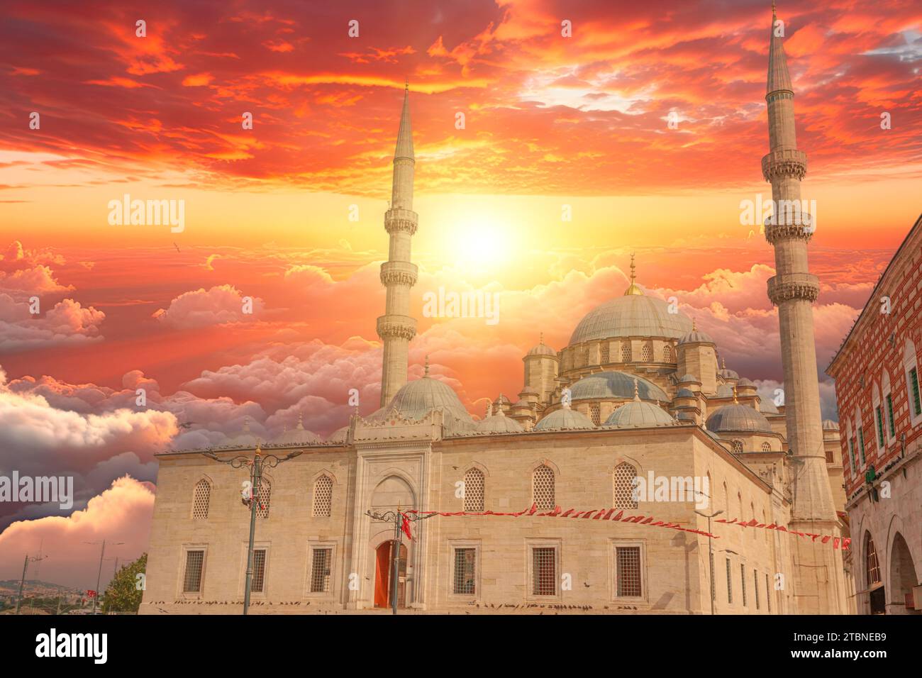 At sunset, Istanbul's New Mosque radiates with an amber hue, its ...