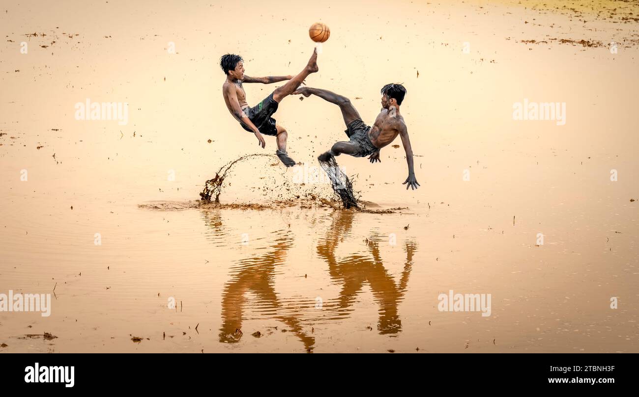 Children playing football in mud hi-res stock photography and images ...