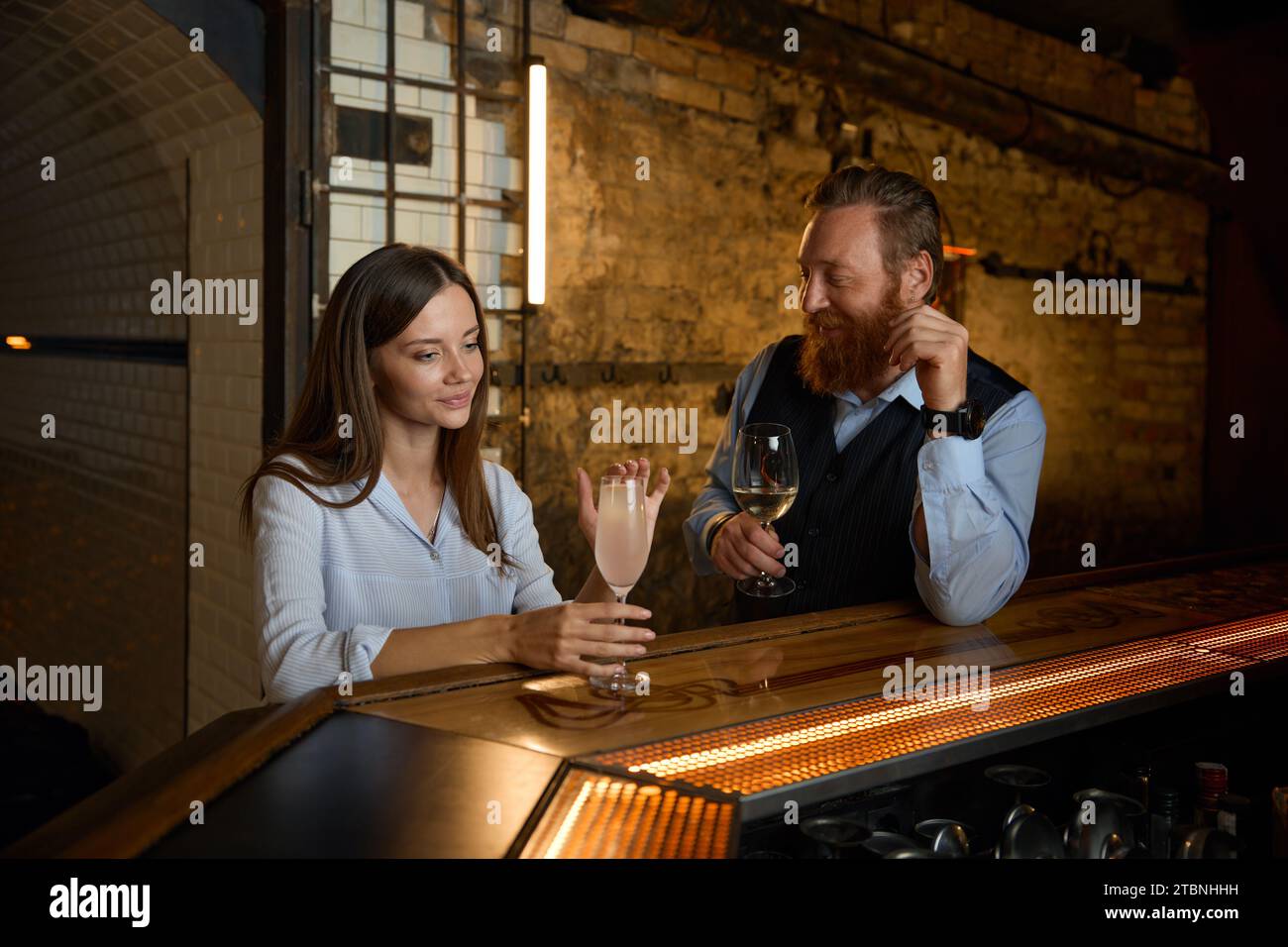 Man picking up woman in bar starting nice conversation Stock Photo - Alamy
