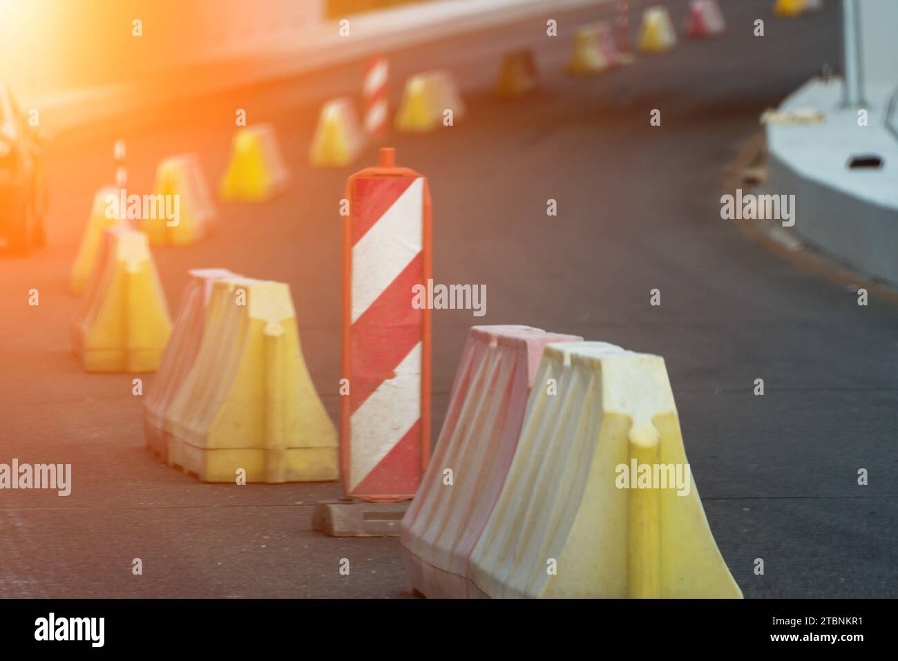 Red, white plastic safety barriers along road. Ensuring road safety ...