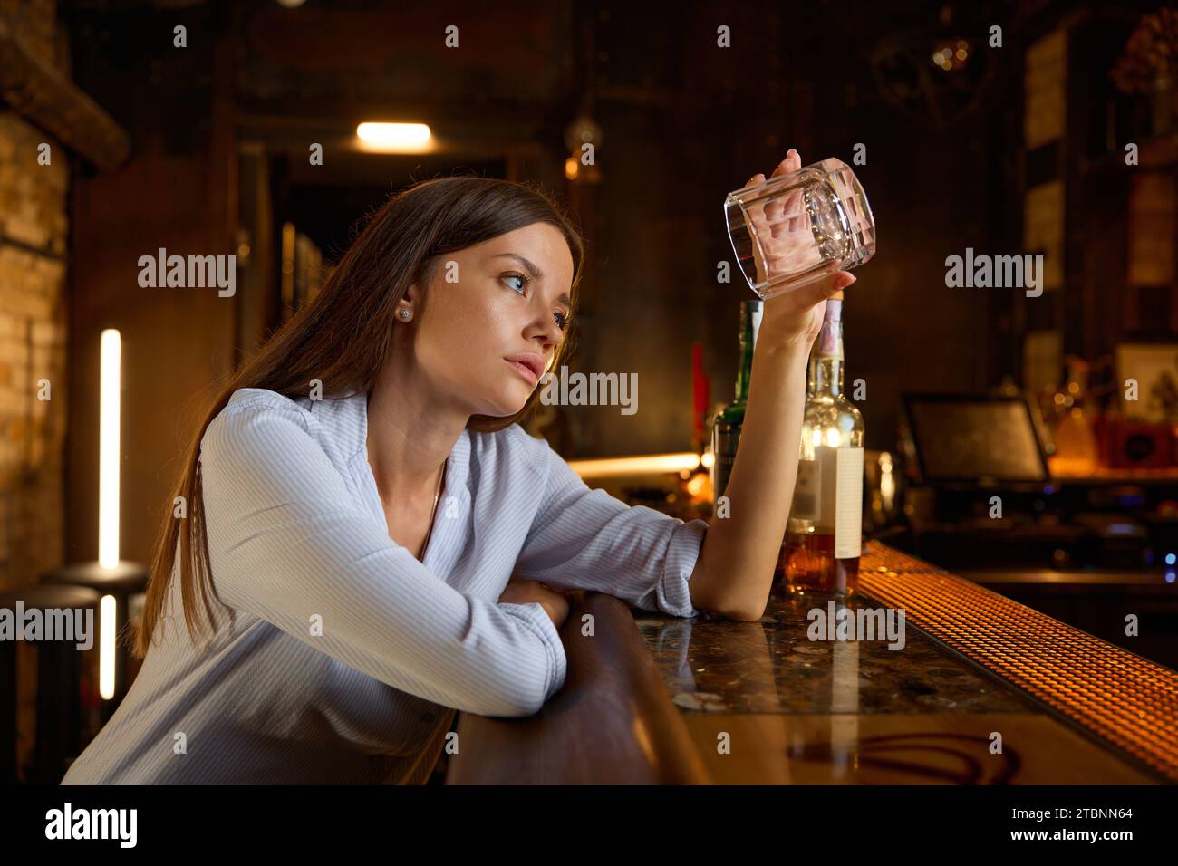 Pensive woman sitting bar hi-res stock photography and images - Alamy