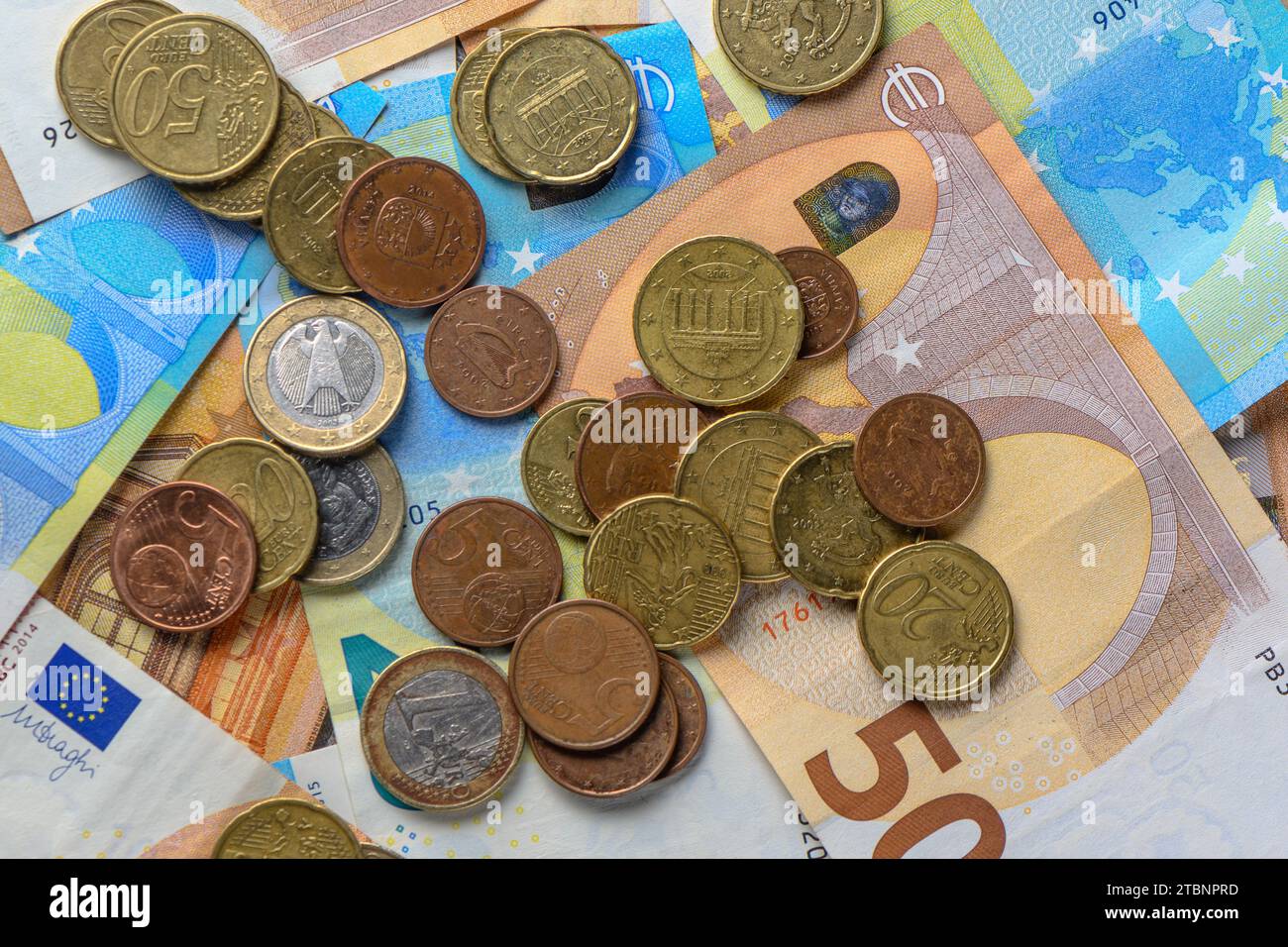 Euro bills and coins scattered on the table as a background 4 Stock Photo - Alamy