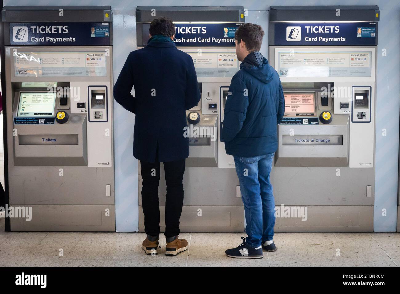 London, UK. 06th Dec, 2023. Passengers use a ticket machine at Waterloo ...