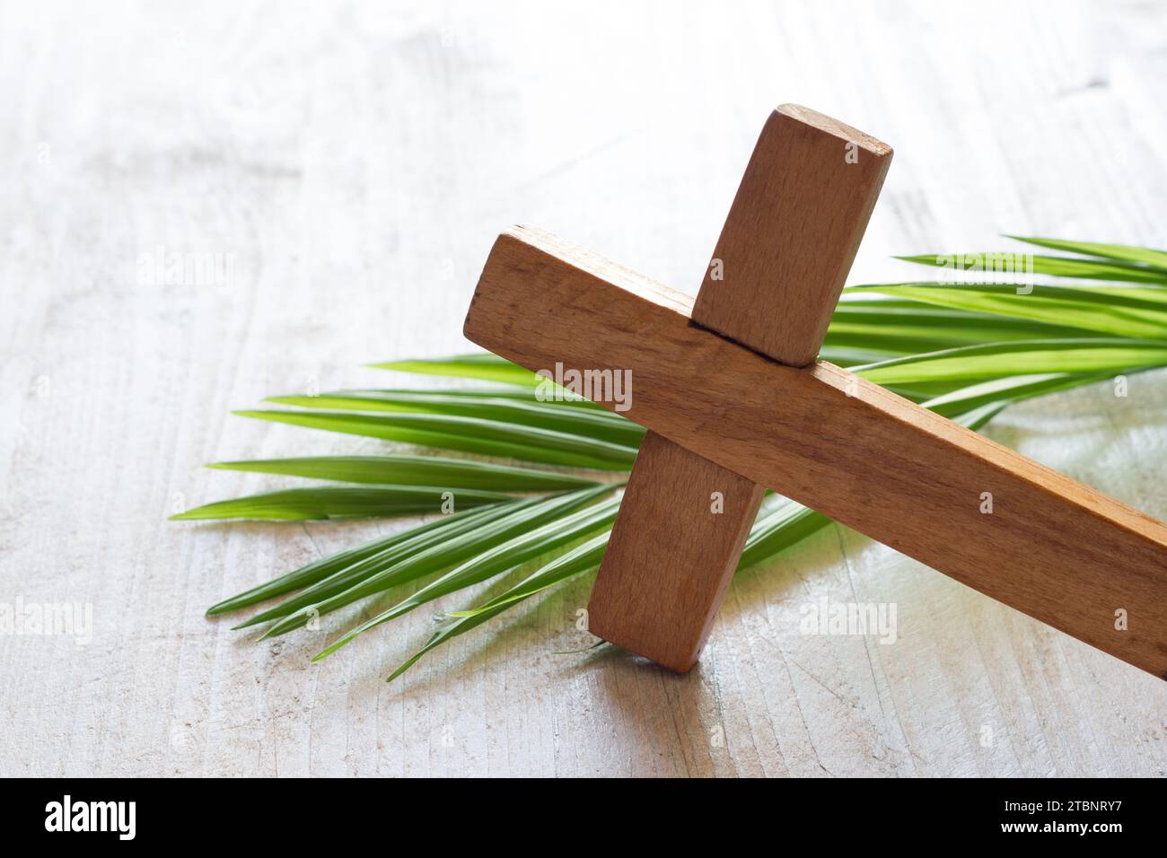 Wooden cross and palm on light background, palm sunday concept Stock ...
