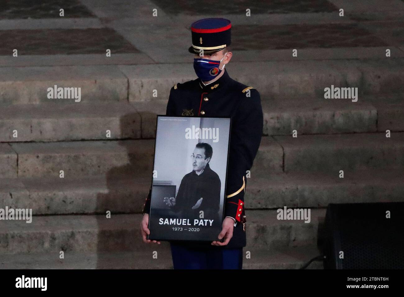 A Republican Guard holds a portrait of Samuel Paty in the courtyard of ...