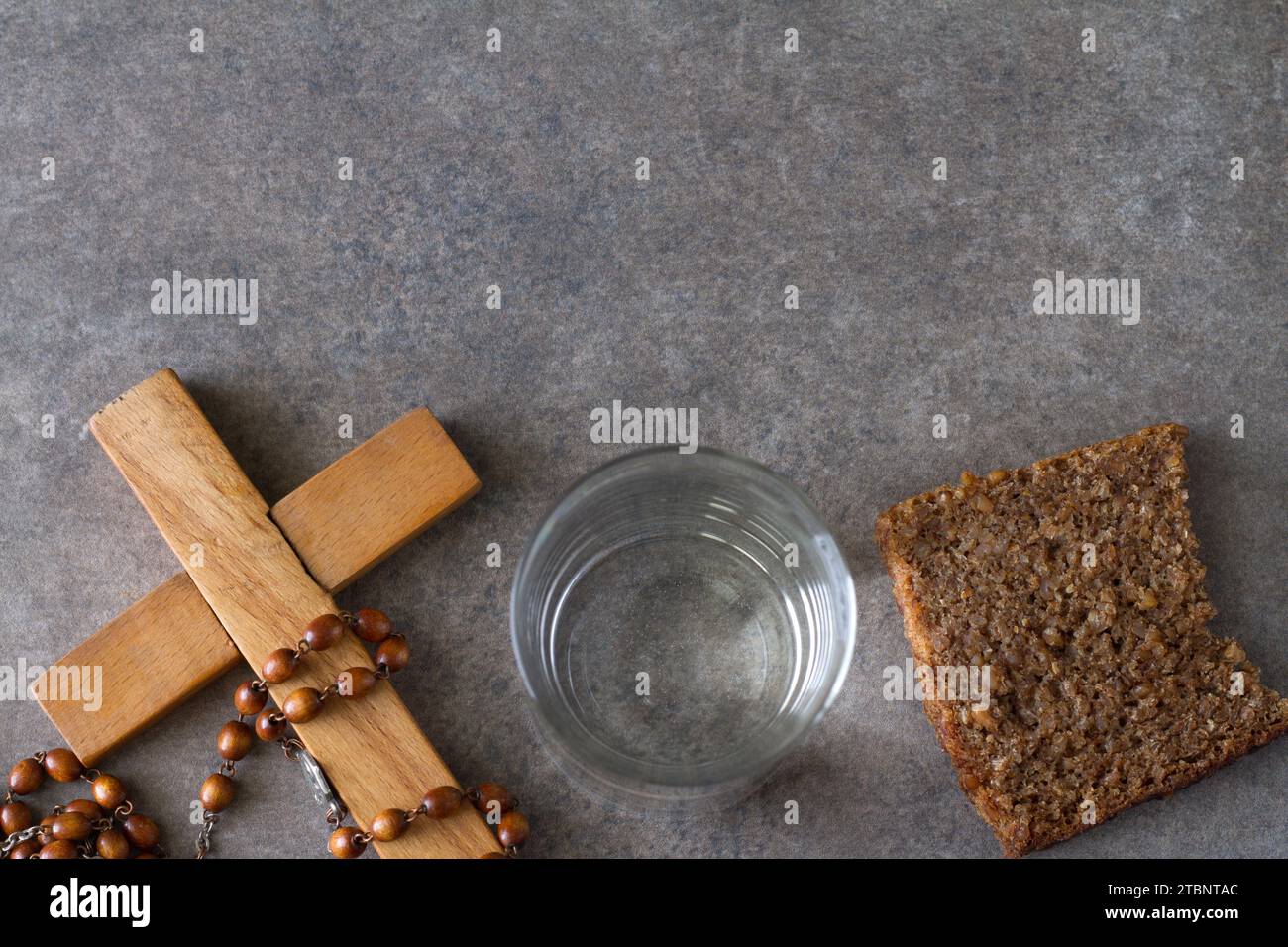 Cross, rosary, water and bread. Lent Season, Holy Week, Good Friday ...