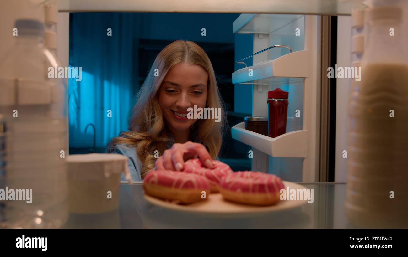 Woman grabbing donut hi-res stock photography and images - Alamy