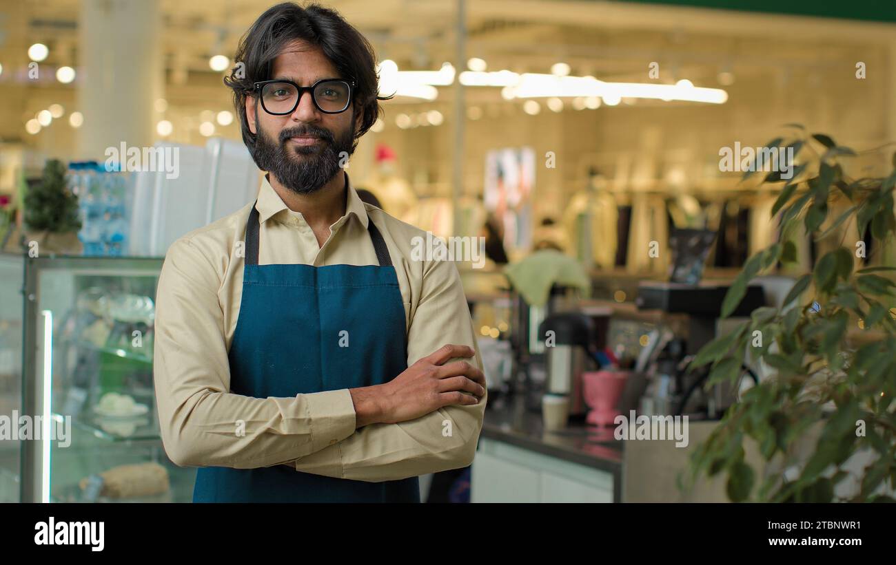 Happy smiling friendly cafe worker guy Indian male waiter in apron ...