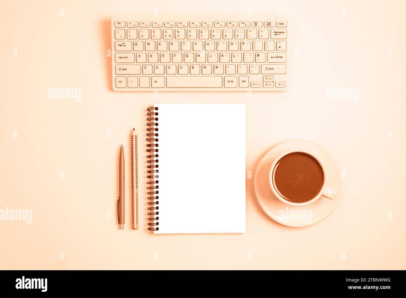 Workplace with computer keyboard, notepad, pen, pencil and cup of ...