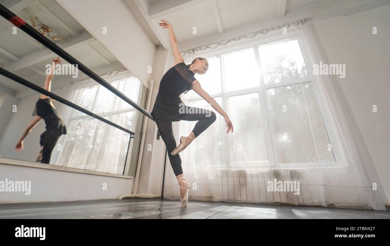 A beautiful Asian woman is dancing at the barre. Ballet dancer Stock ...