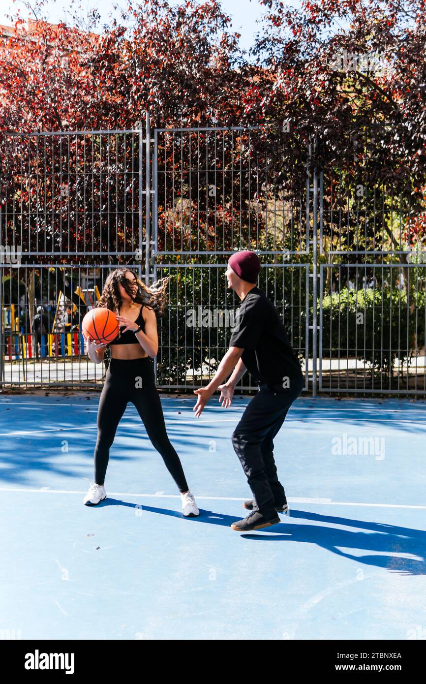 two friends playing basketball on a court Stock Photo - Alamy