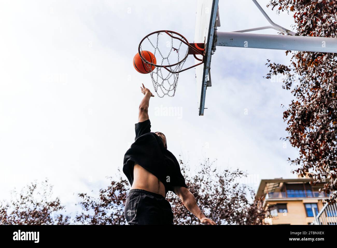 multiethnic boy shooting basket playing basketball Stock Photo - Alamy