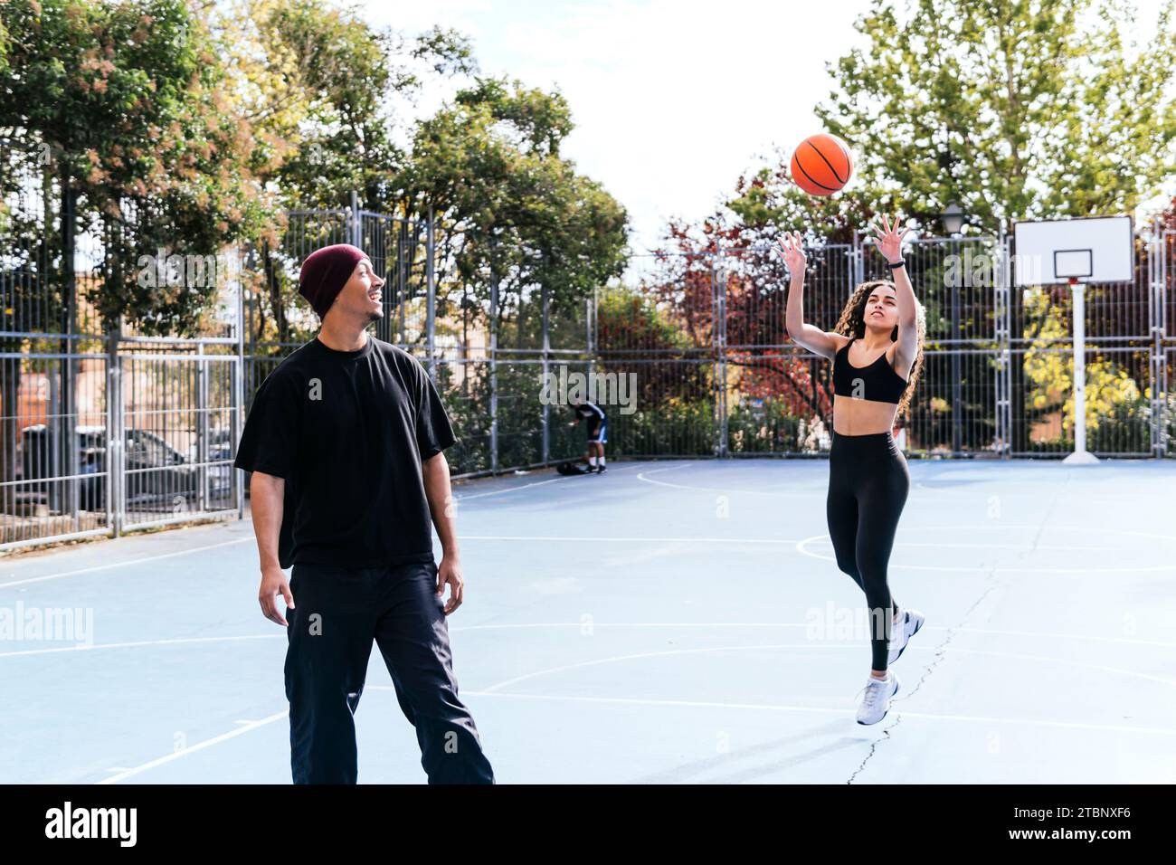 two friends throwing the basketball playing Stock Photo - Alamy