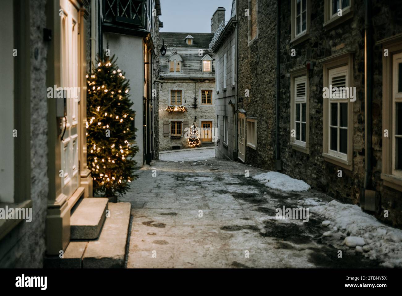 An cozy street in winter at Christmas in the Old City of Quebec Stock ...