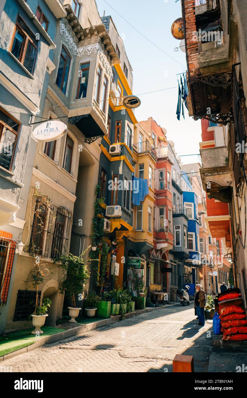 Man on a street with colored houses in the sunlight in Istanbul Stock ...