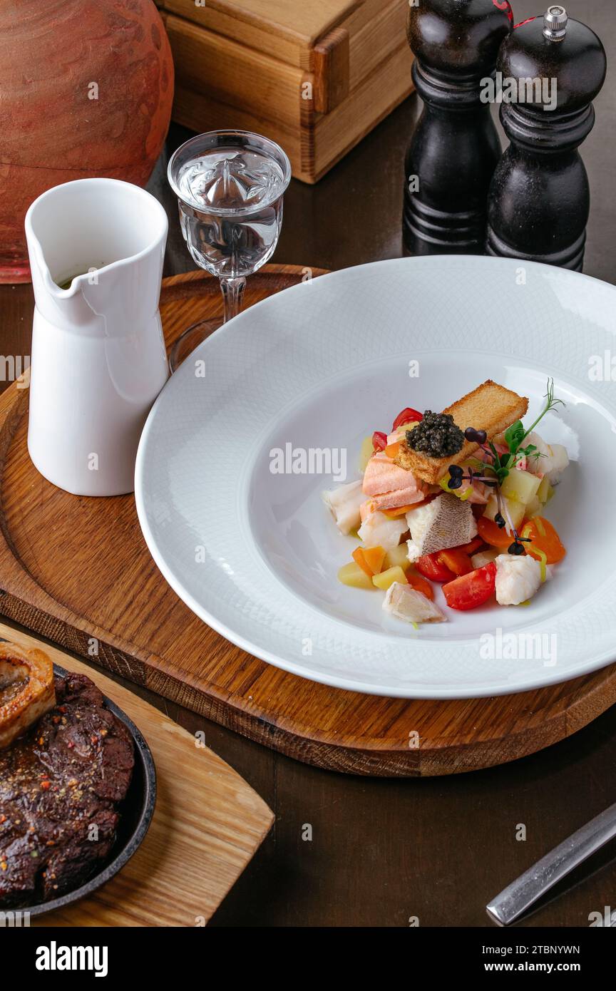 restaurant serving of fish soup Stock Photo - Alamy