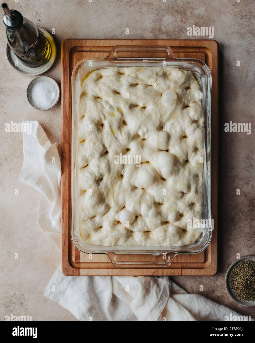 Top view of dimpled focaccia bread dough in dish before baking Stock ...