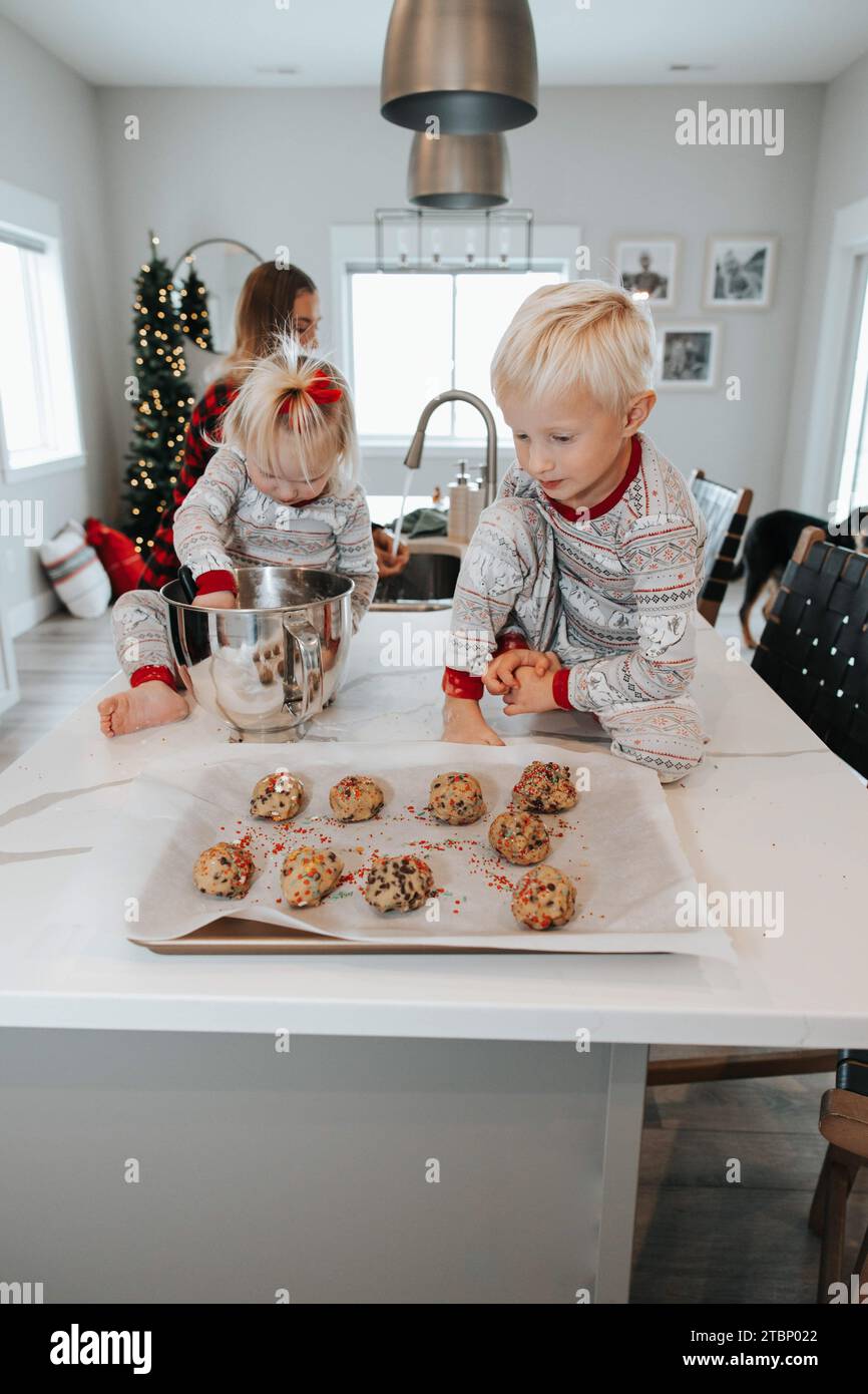 Kids admire Christmas cookies on counter Stock Photo - Alamy