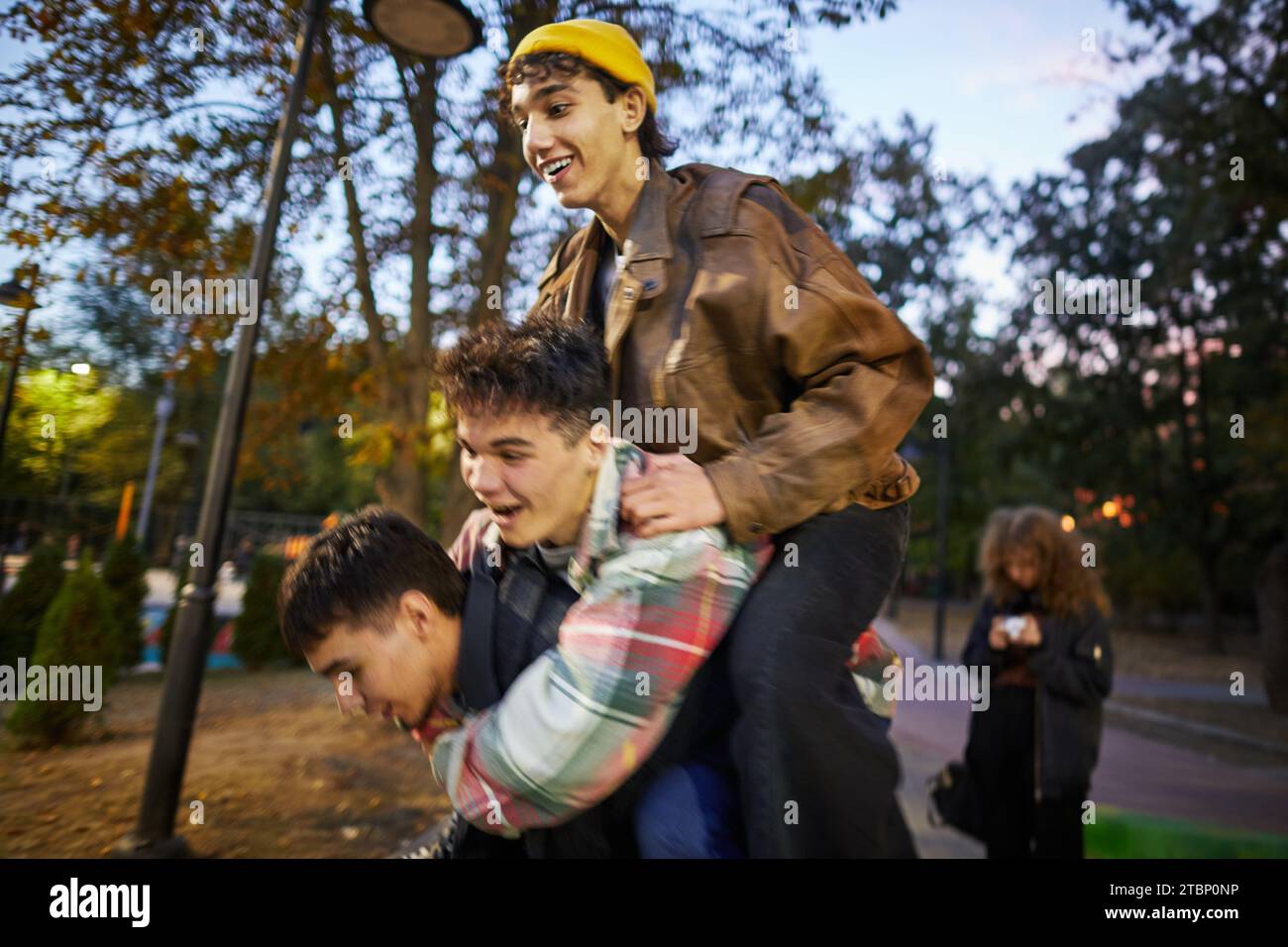 three friends on each other's back in the evening Stock Photo - Alamy