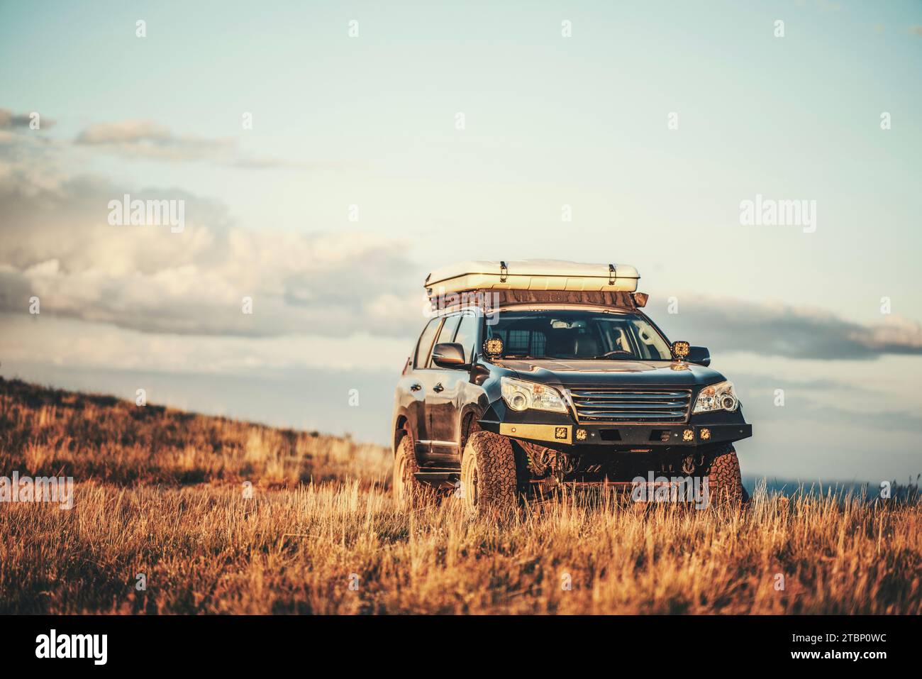 Gray 4x4 Vehicle Parked in Tall Grass at Sunset on a Mountain Stock ...