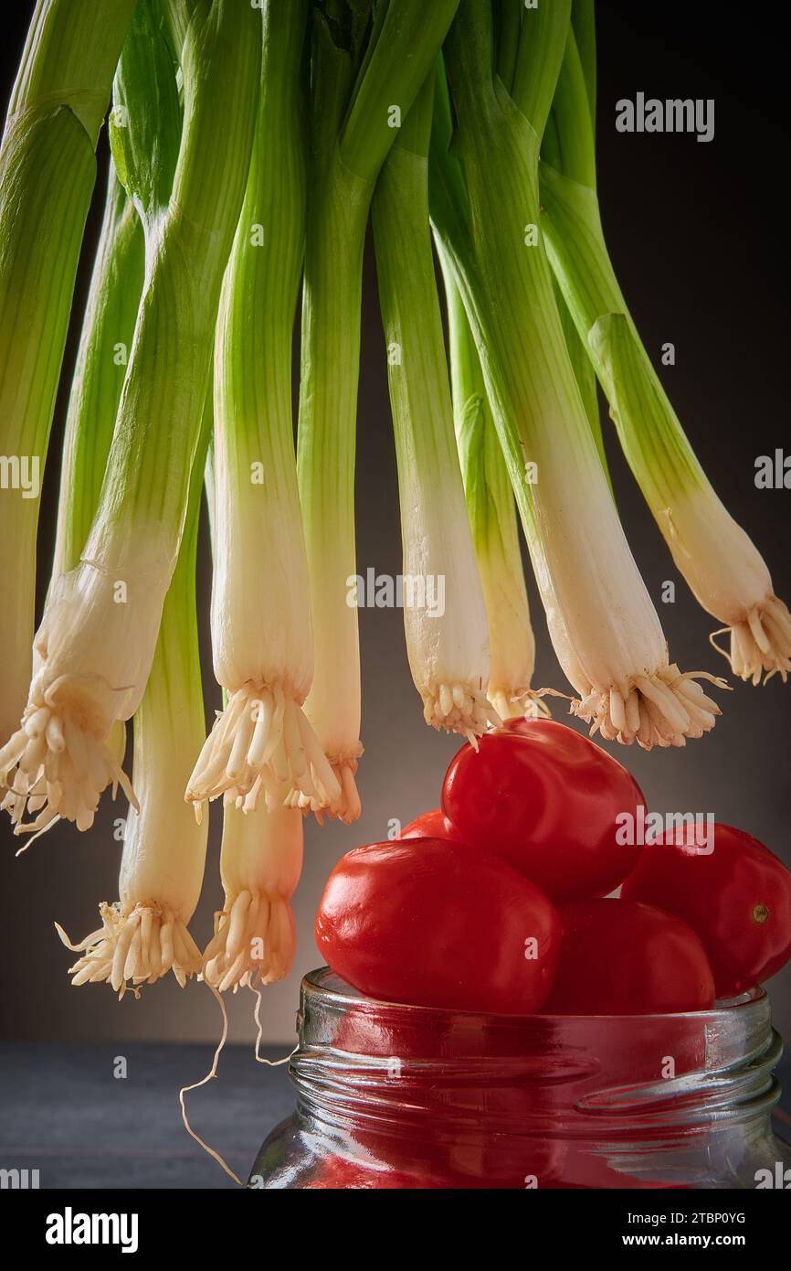 Scallions (green onions) and grape tomatoes Stock Photo - Alamy