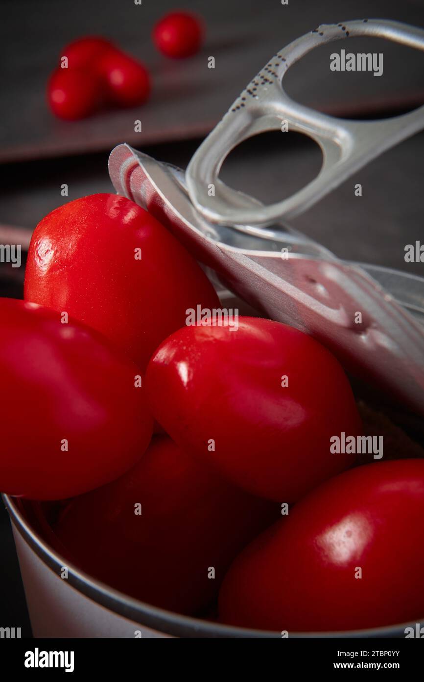 Grape tomatoes bursting from a pop top can Stock Photo - Alamy