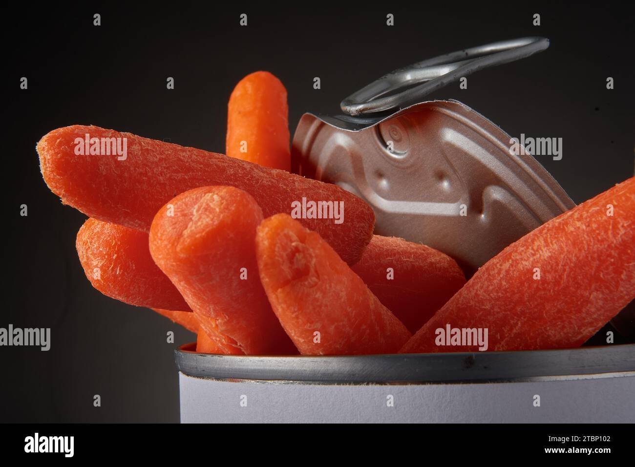 Mini carrots bursting from a pop top can Stock Photo - Alamy