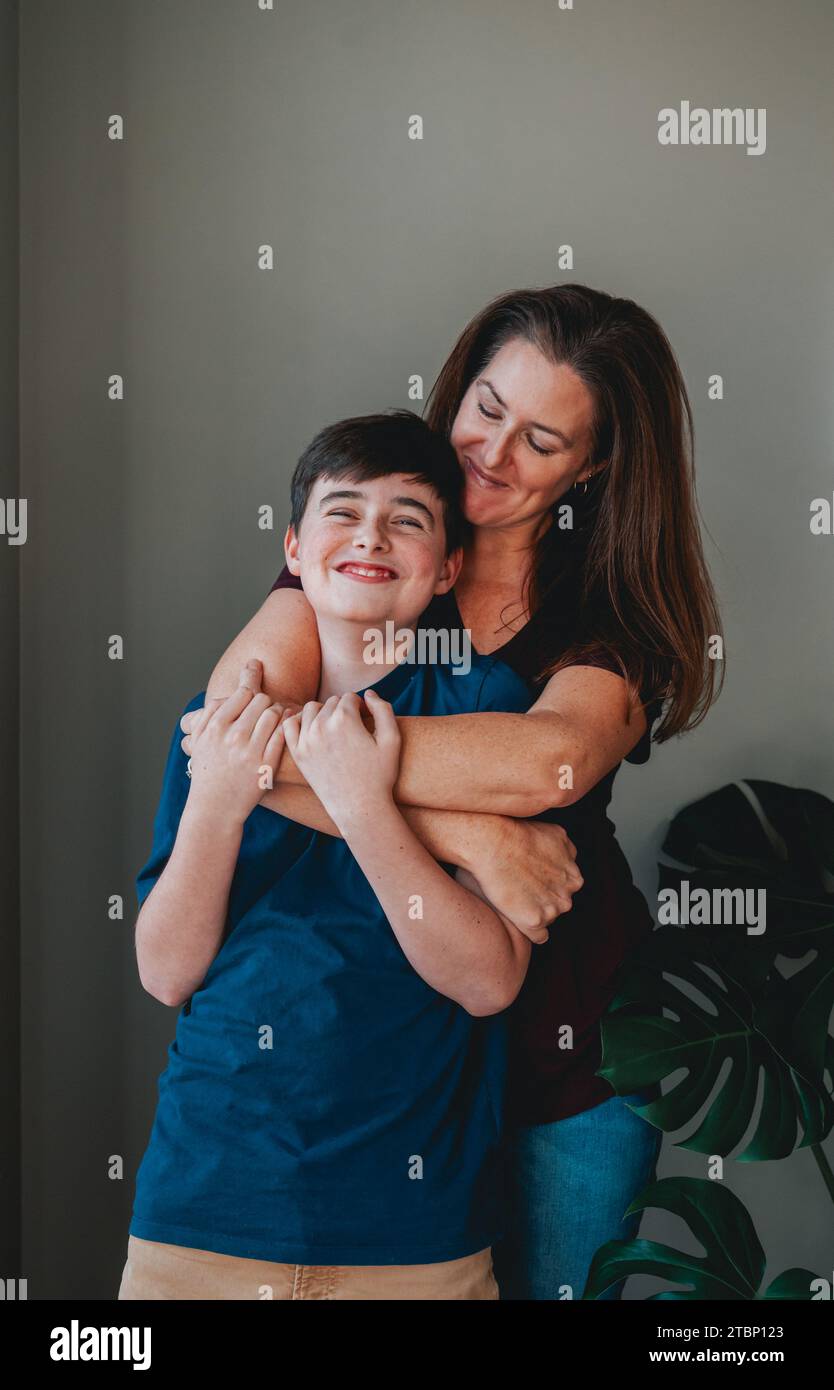 Happy mother and son having fun playfully embracing at home Stock Photo ...