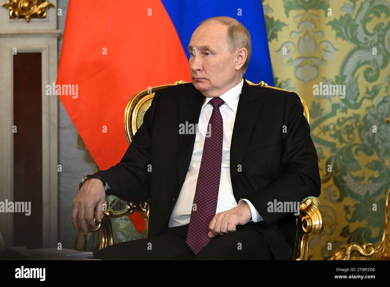 Russian President Vladimir Putin listens to Iranian President Ebrahim ...